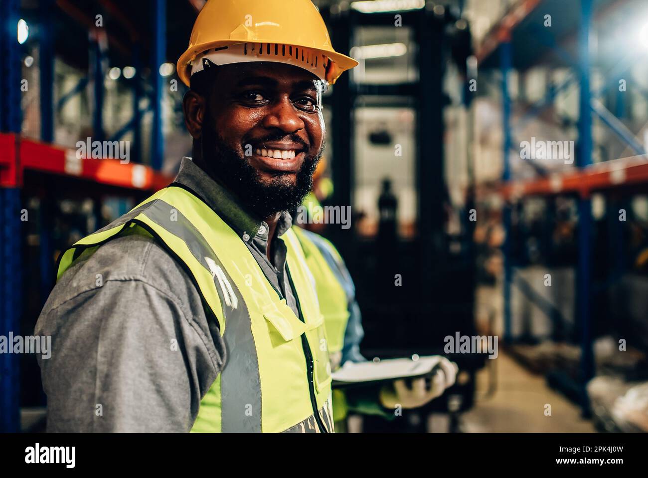Portrait of warehouse worker smiling looking camera Stock Photo - Alamy