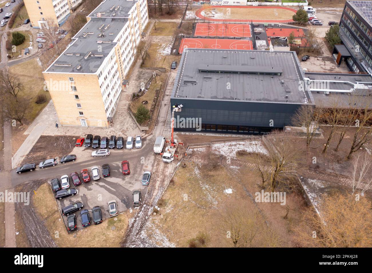 Drone photography of people putting sign on a building during cloudy ...