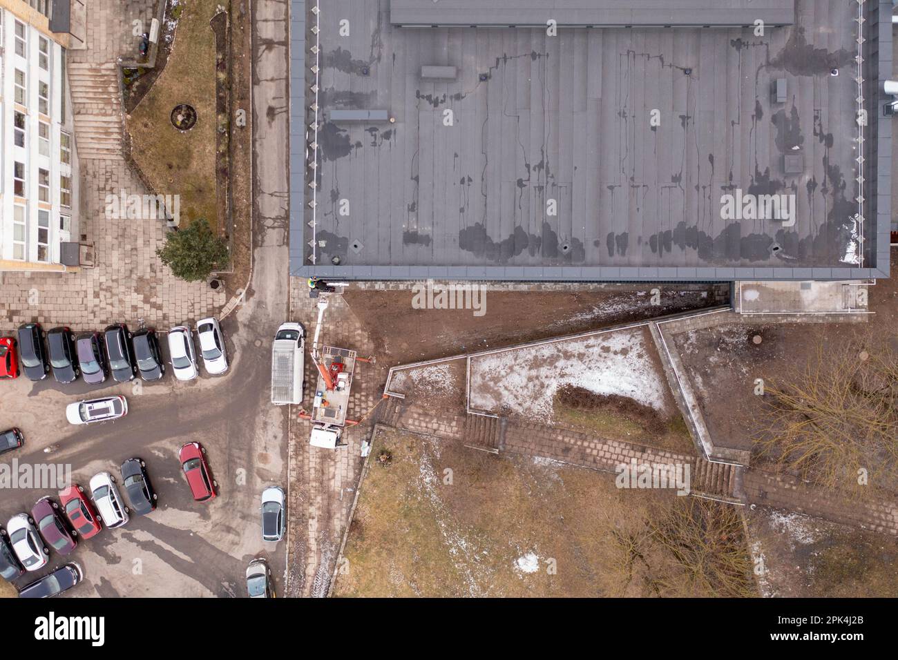 Drone photography of people putting sign on a building during cloudy ...