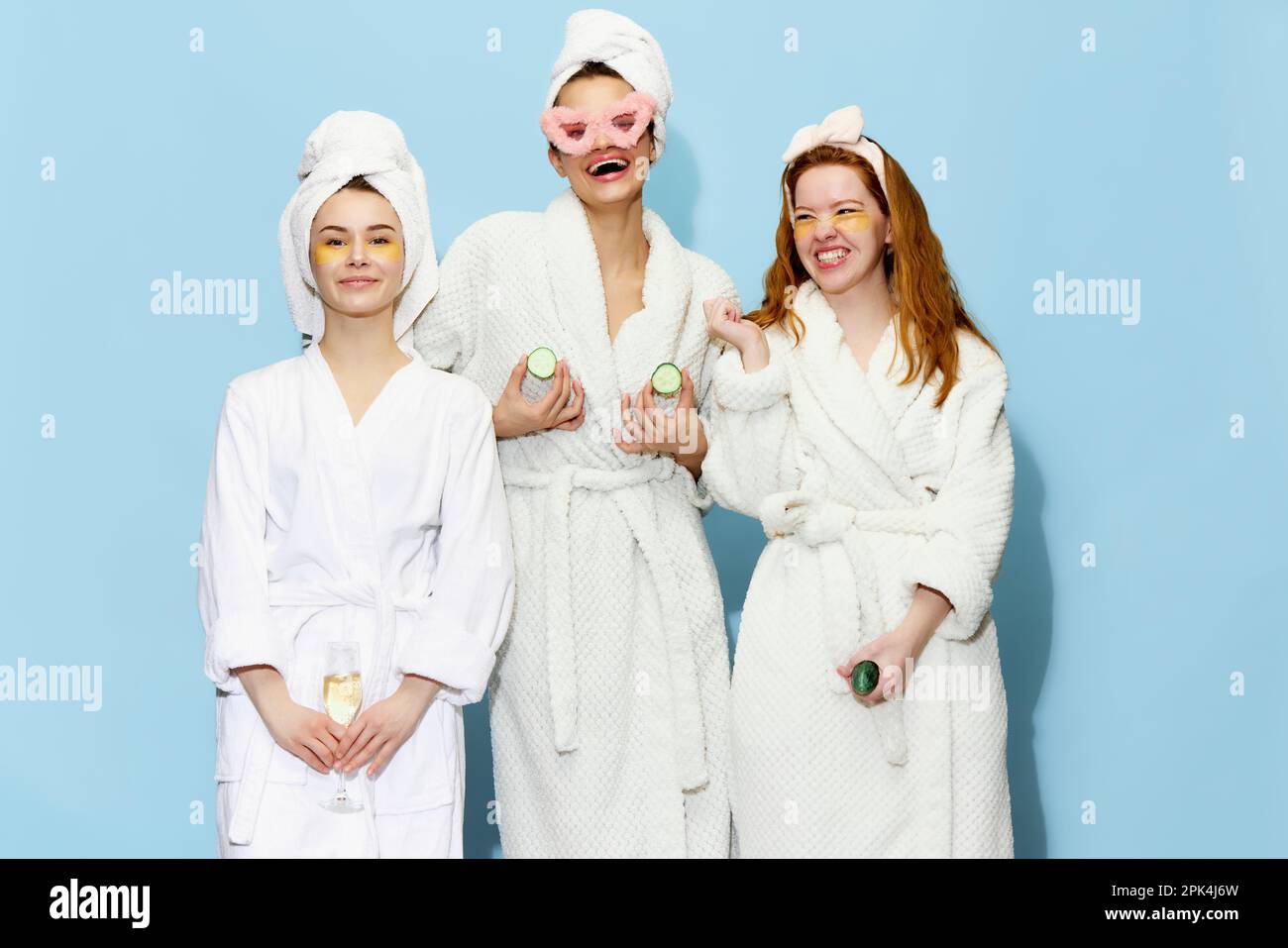 Cheerful, positive, delightful young girls in bathrobes and face having ...