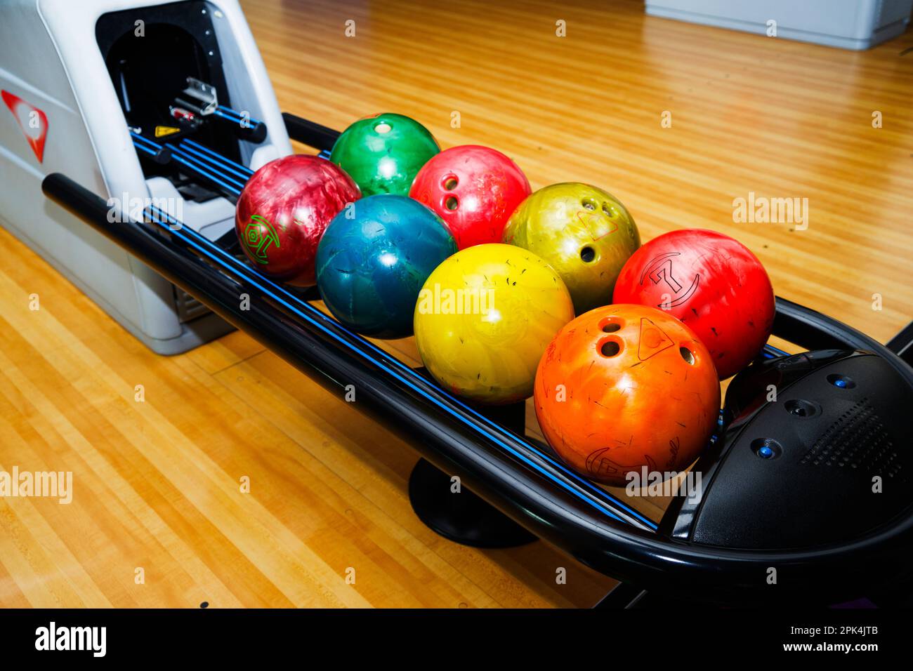 Stand with colorful bowling balls in club no people Stock Photo - Alamy