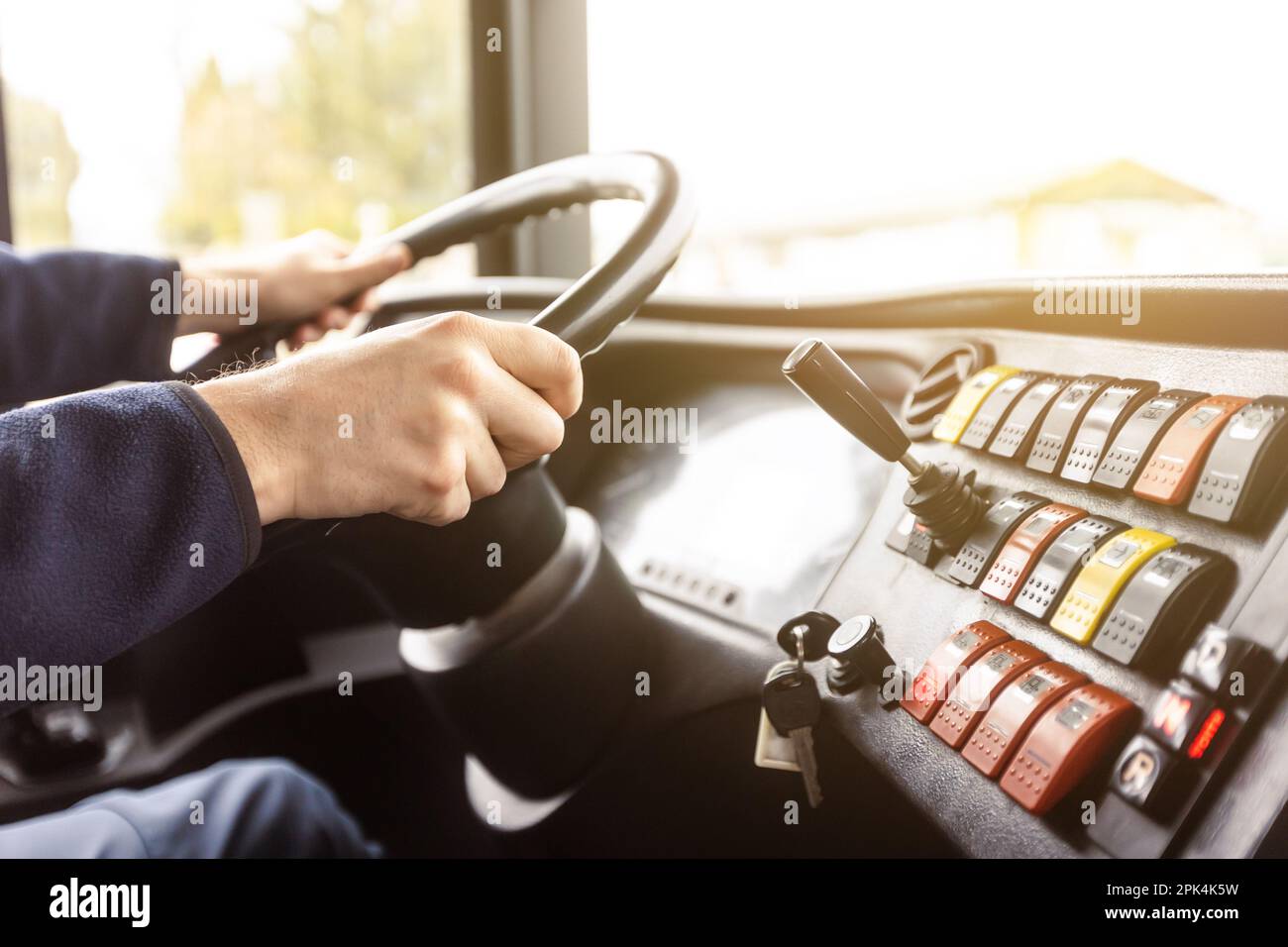 Hands of the driver in a modern bus according to the ride, detail of ...