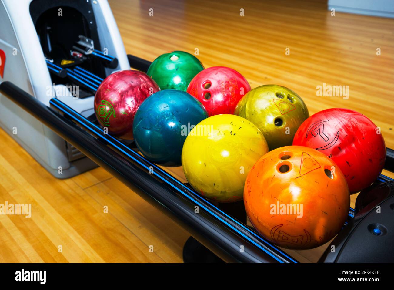 Stand with colorful bowling balls in club no people Stock Photo - Alamy