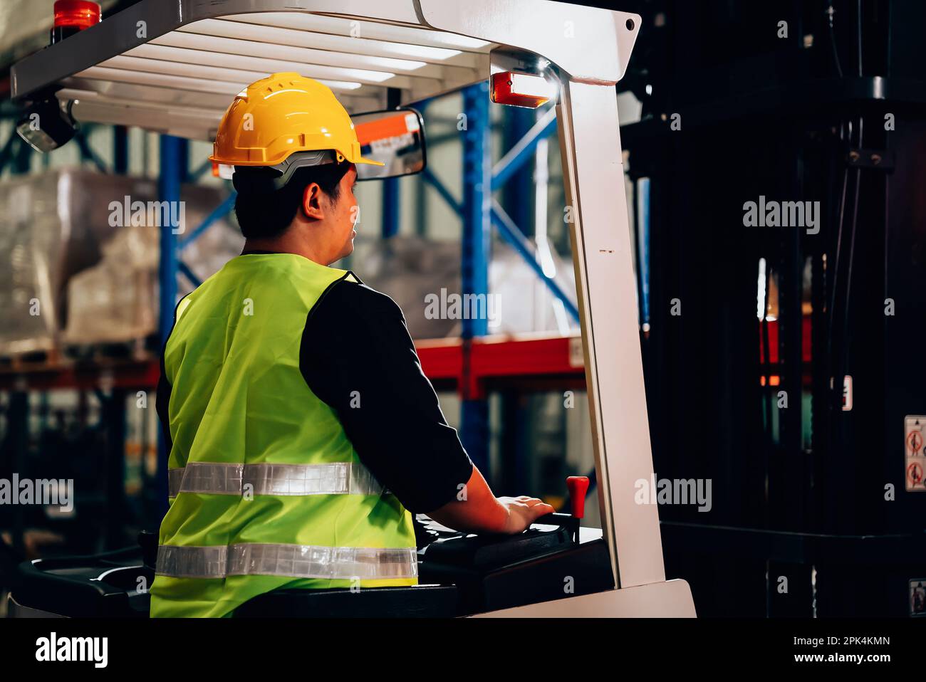 Professional warehouse worker driver moving cardboard boxes Stock Photo ...