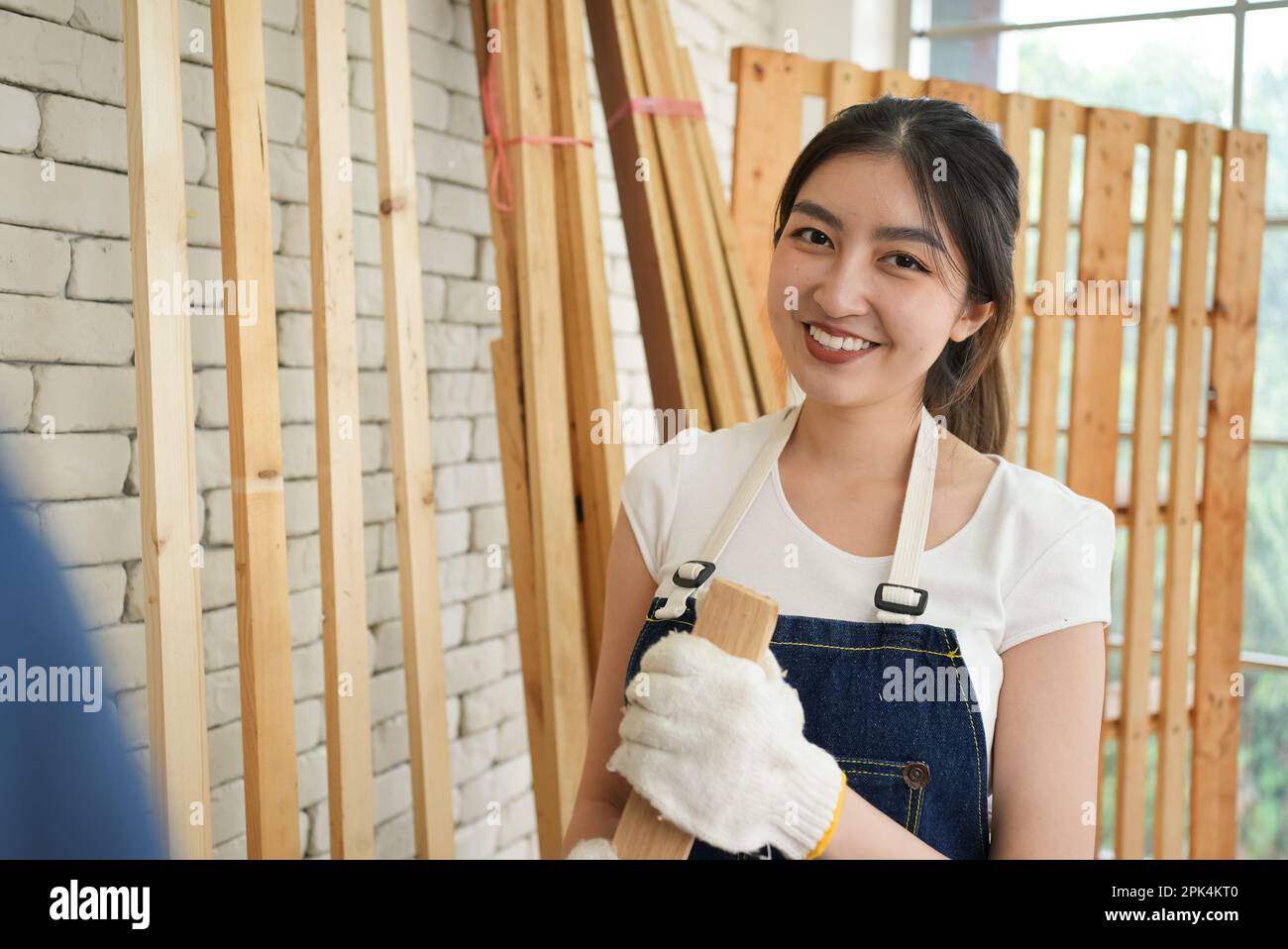 Portrait of happy carpenters designing and planing wood products in ...