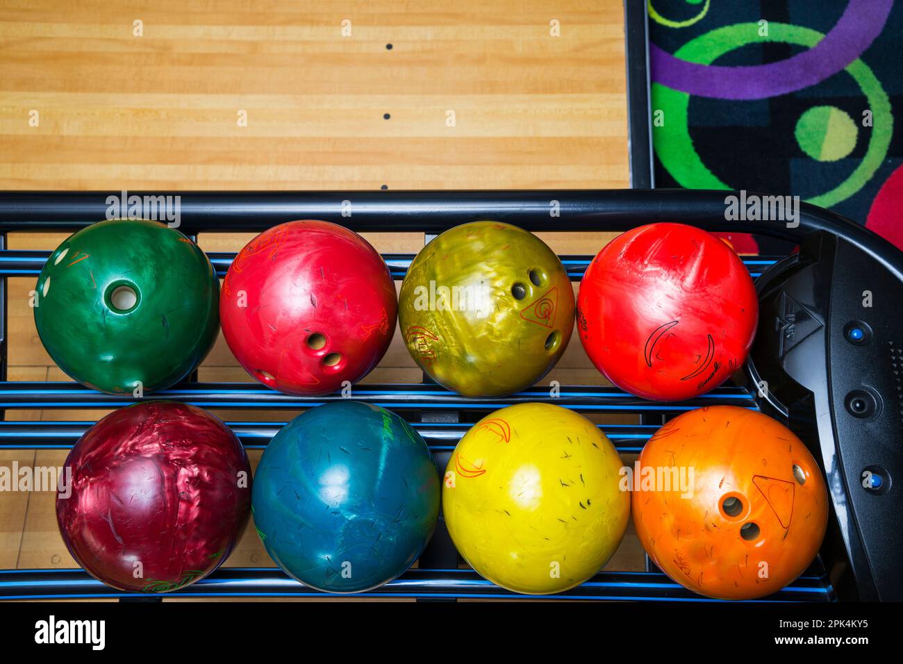 Stand with colorful bowling balls in club no people Stock Photo - Alamy