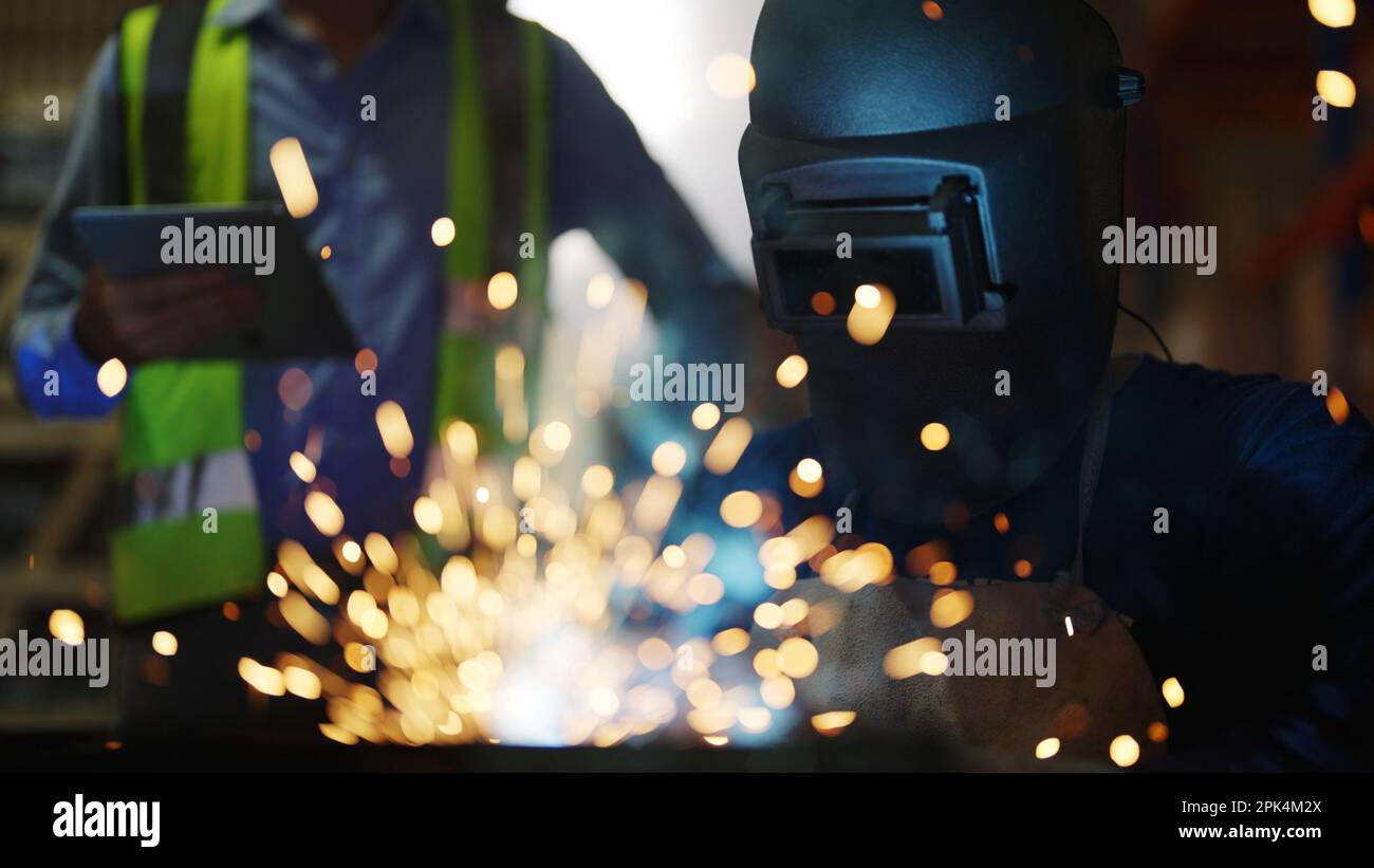 Welders welding steel in factory, Welders with protective mask Stock ...
