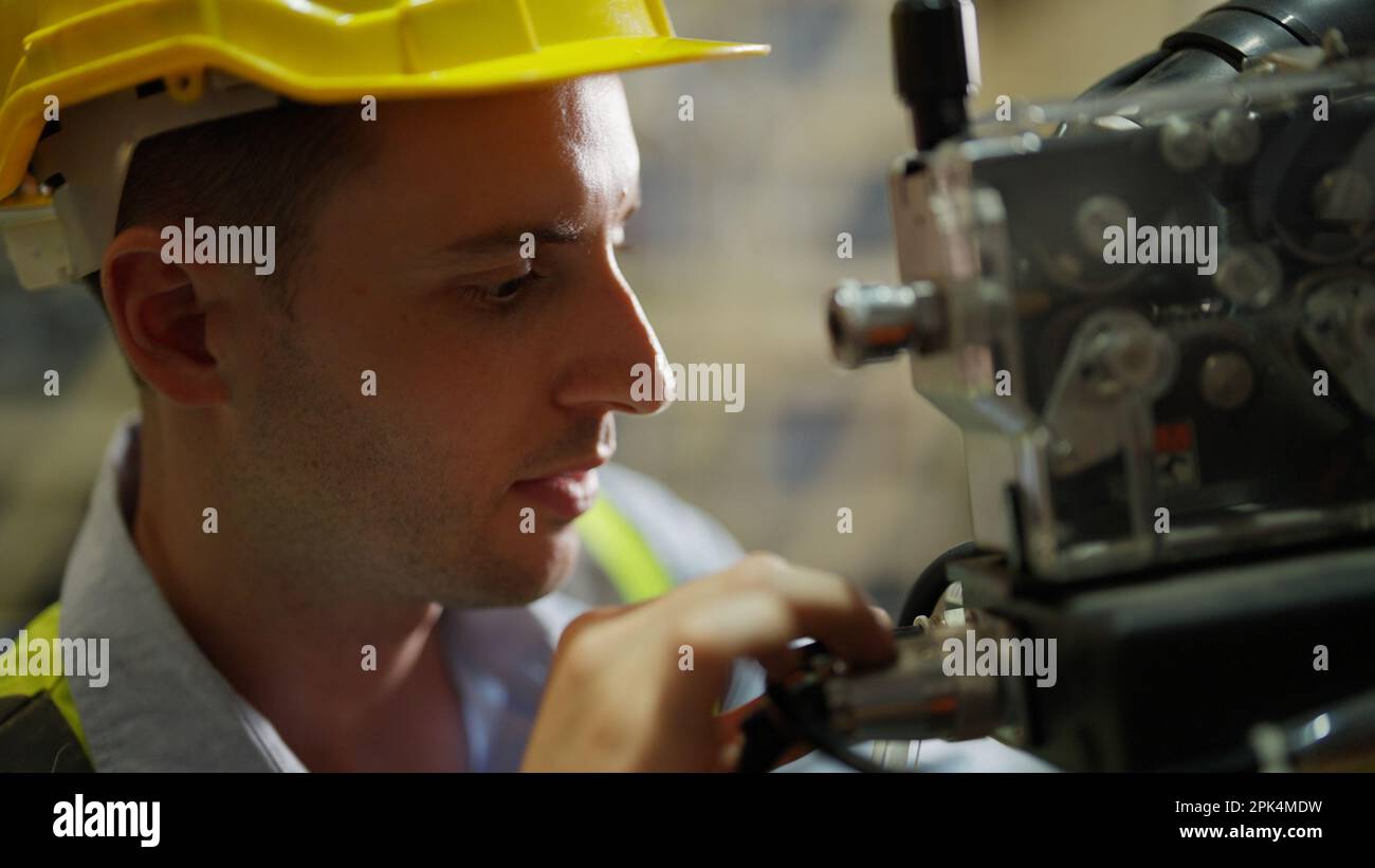 Maintenance engineer with robotic arms at industrial factory Stock ...