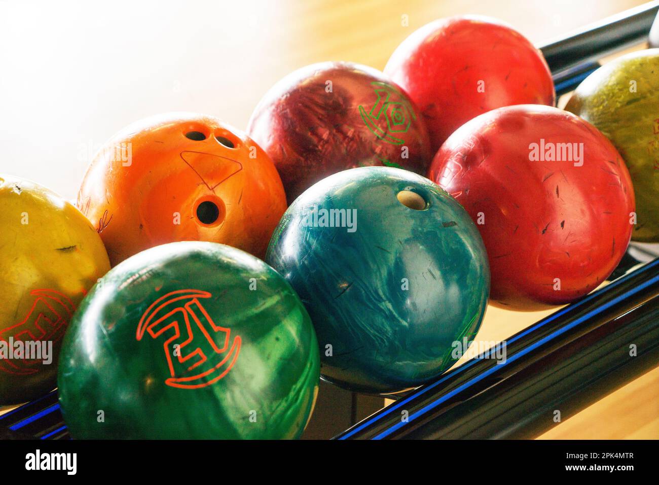 Stand with colorful bowling balls in club no people Stock Photo - Alamy