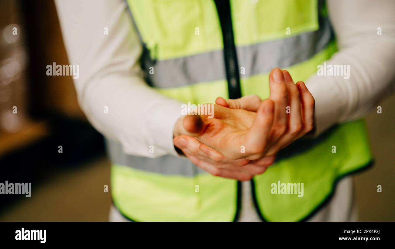 Hardworking male warehouse engineer suffering from hand injury Stock ...