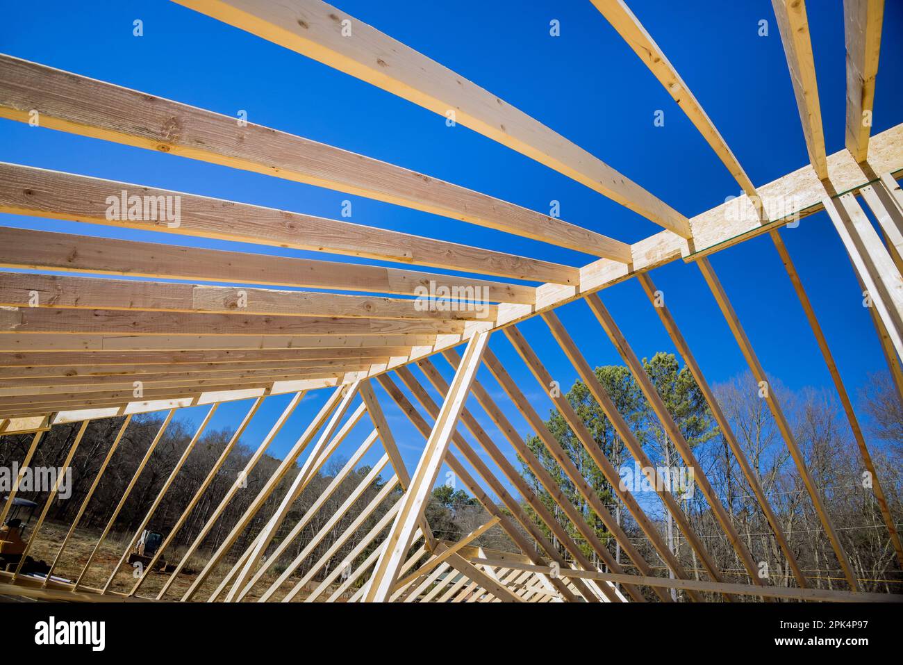 New under construction of timber truss framed building with rafters roof beams wooden joists ...