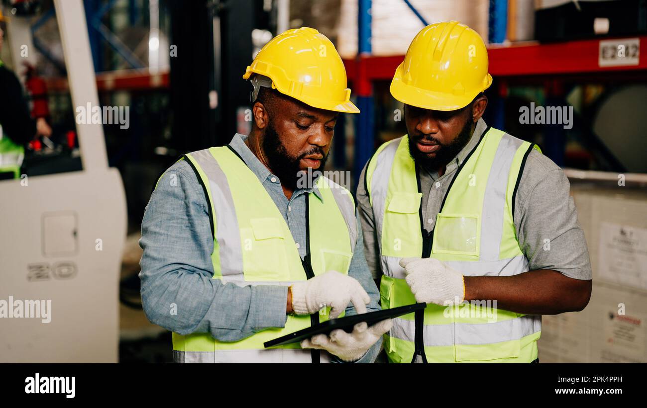 Two warehouse workers checking and controlling boxes in warehouse Stock ...