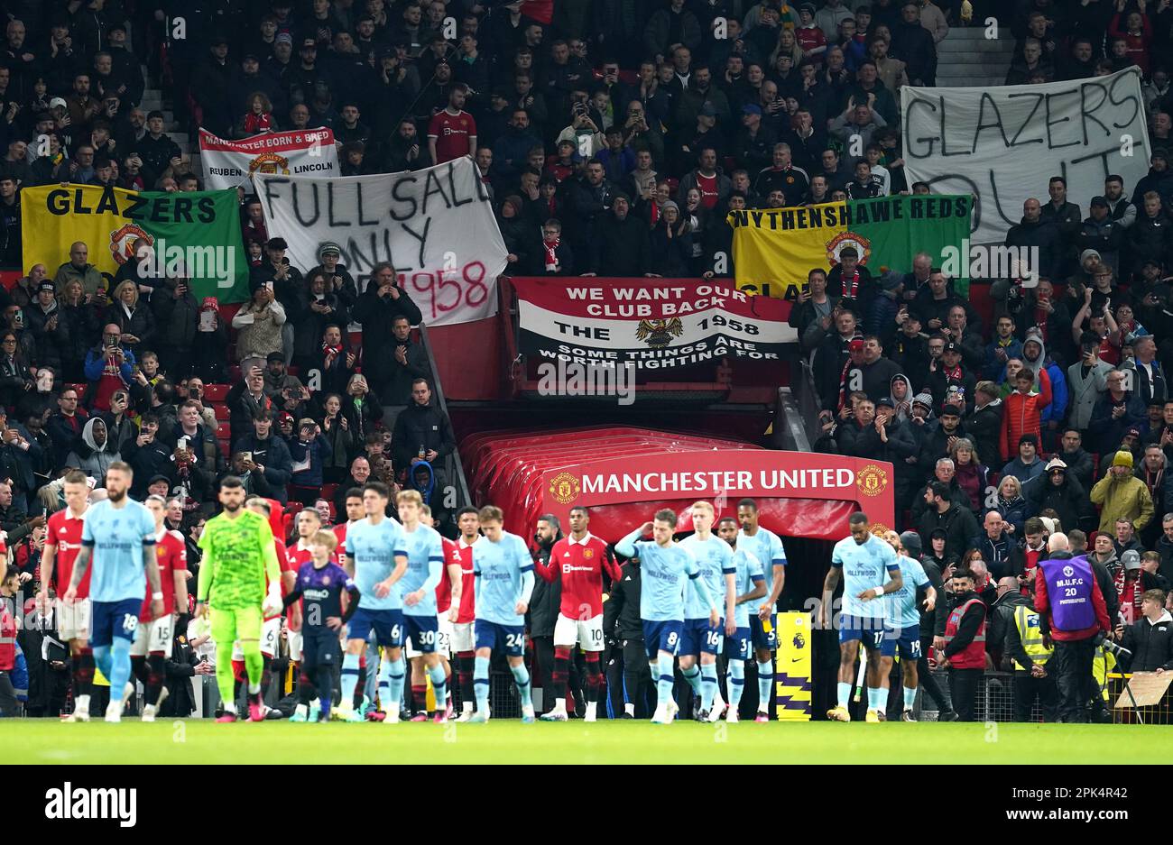 Manchester United and Brentford players walk onto the field as fans ...