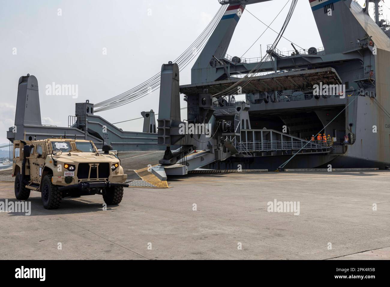 U.S. Service Members work with Filipino contractors by offloading ...