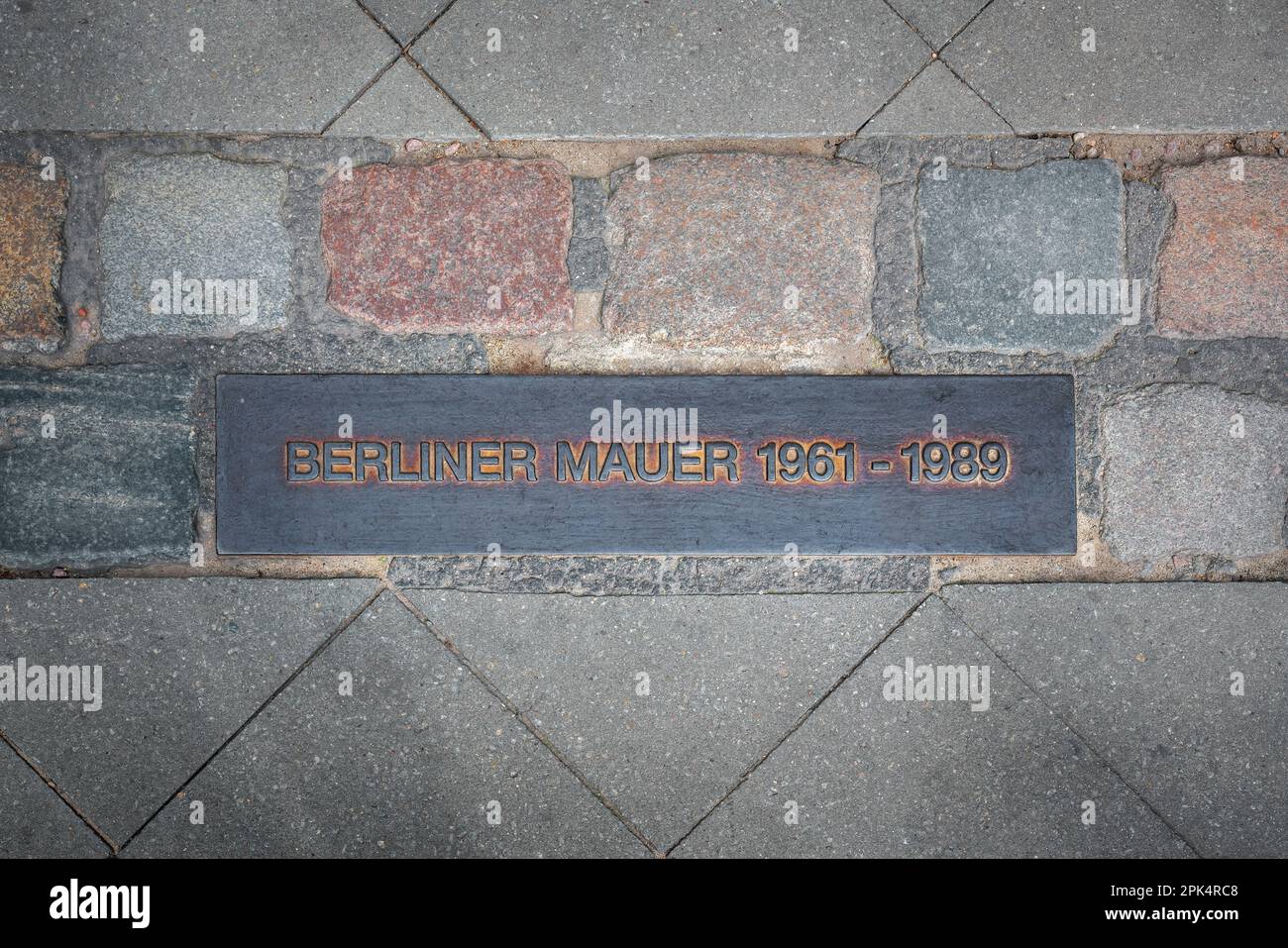 Markings and plaque on the floor indicating where Berlin Wall used to ...