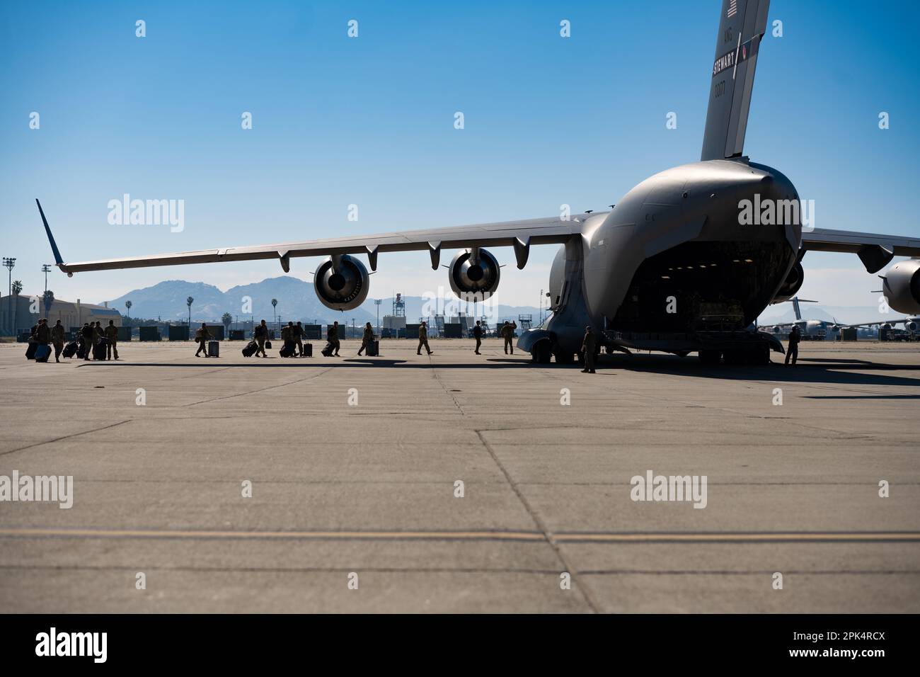 Airmen assigned to the 163d Attack Wing board a C-17 aircraft assigned ...