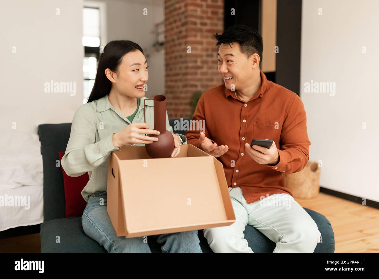 Positive asian husband and wife new owners renters of apartment ...