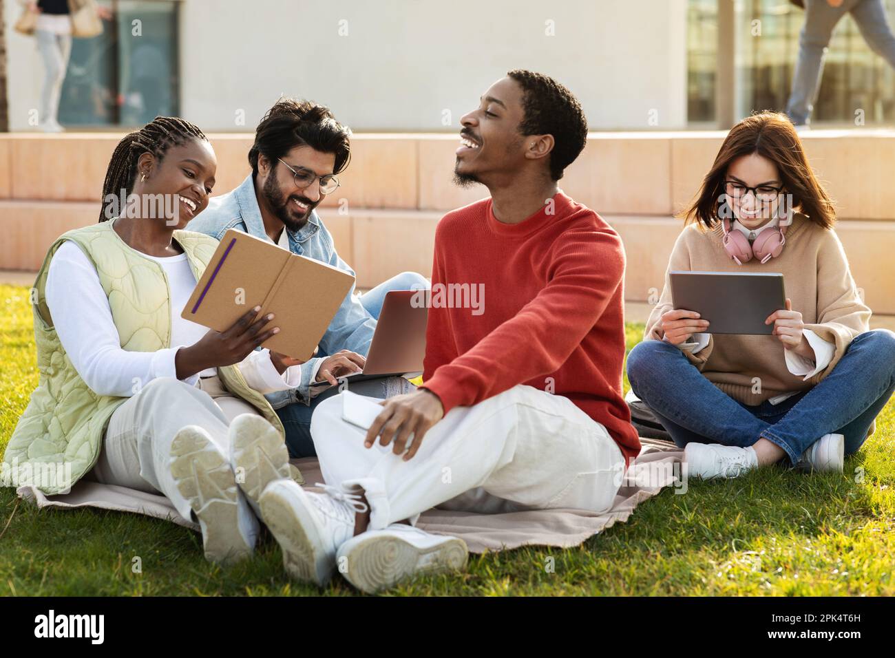 Happy millennial multiethnic modern students study at tablet together ...