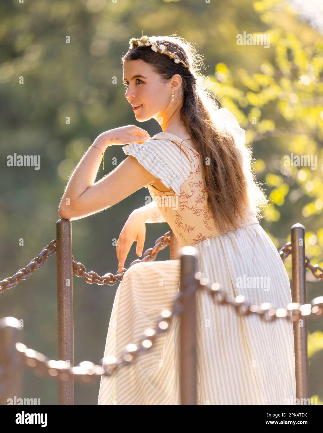 Young Woman in a Cottage Core Attire on a Bridge Surrounded by Trees ...