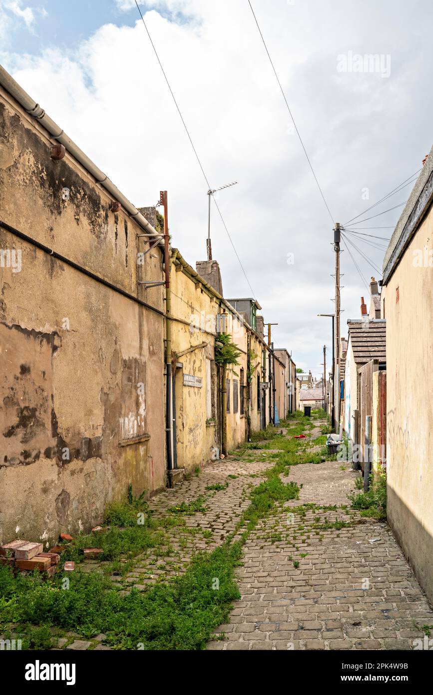 View along alleyway between buildings Stock Photo - Alamy
