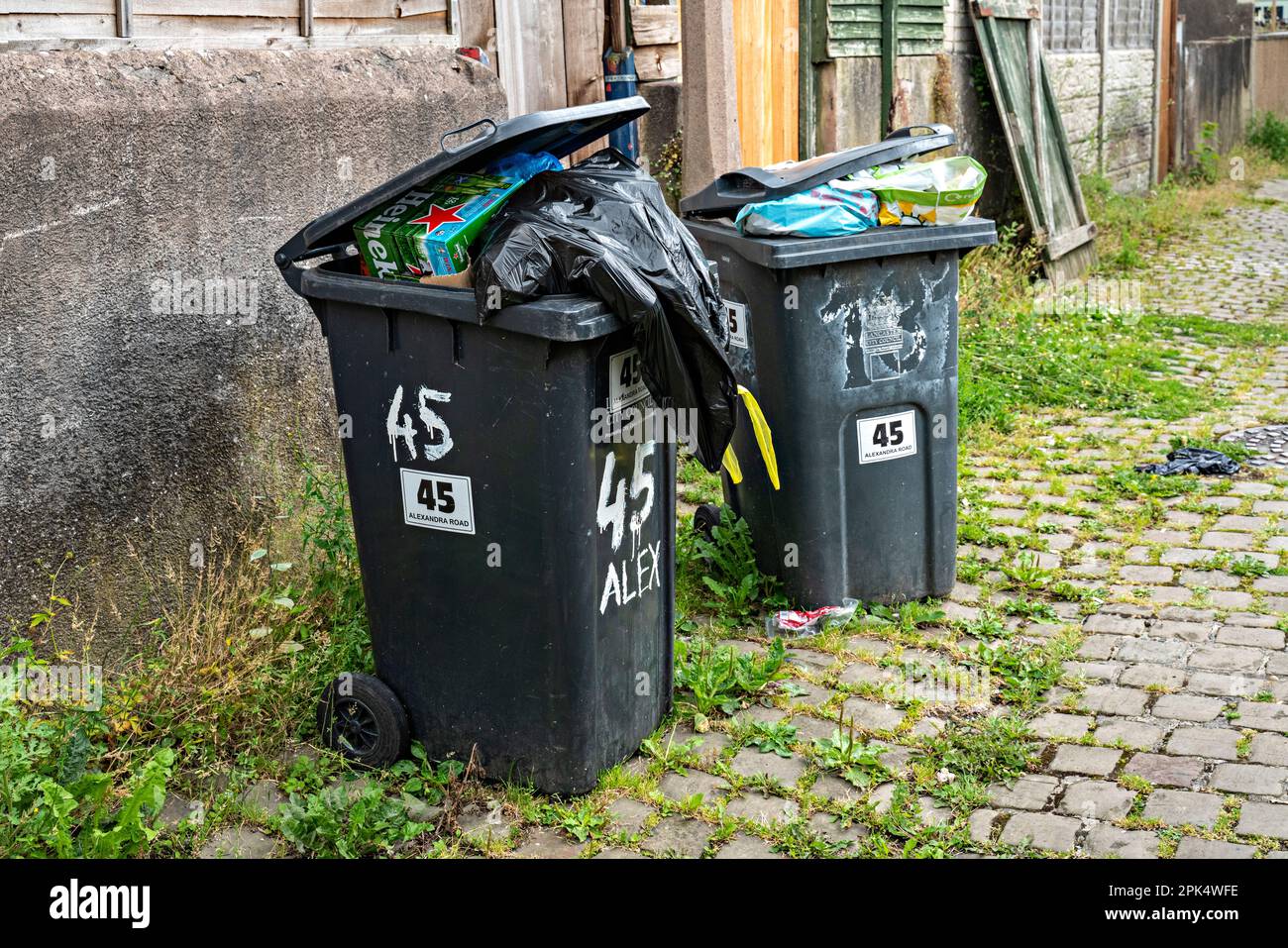 Refuse bins in town backstreet Stock Photo - Alamy