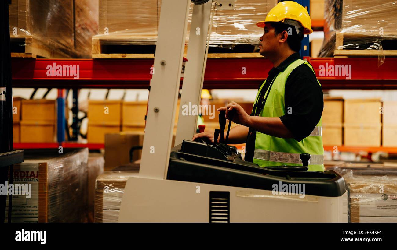 Professional warehouse worker driver moving cardboard boxes Stock Photo ...