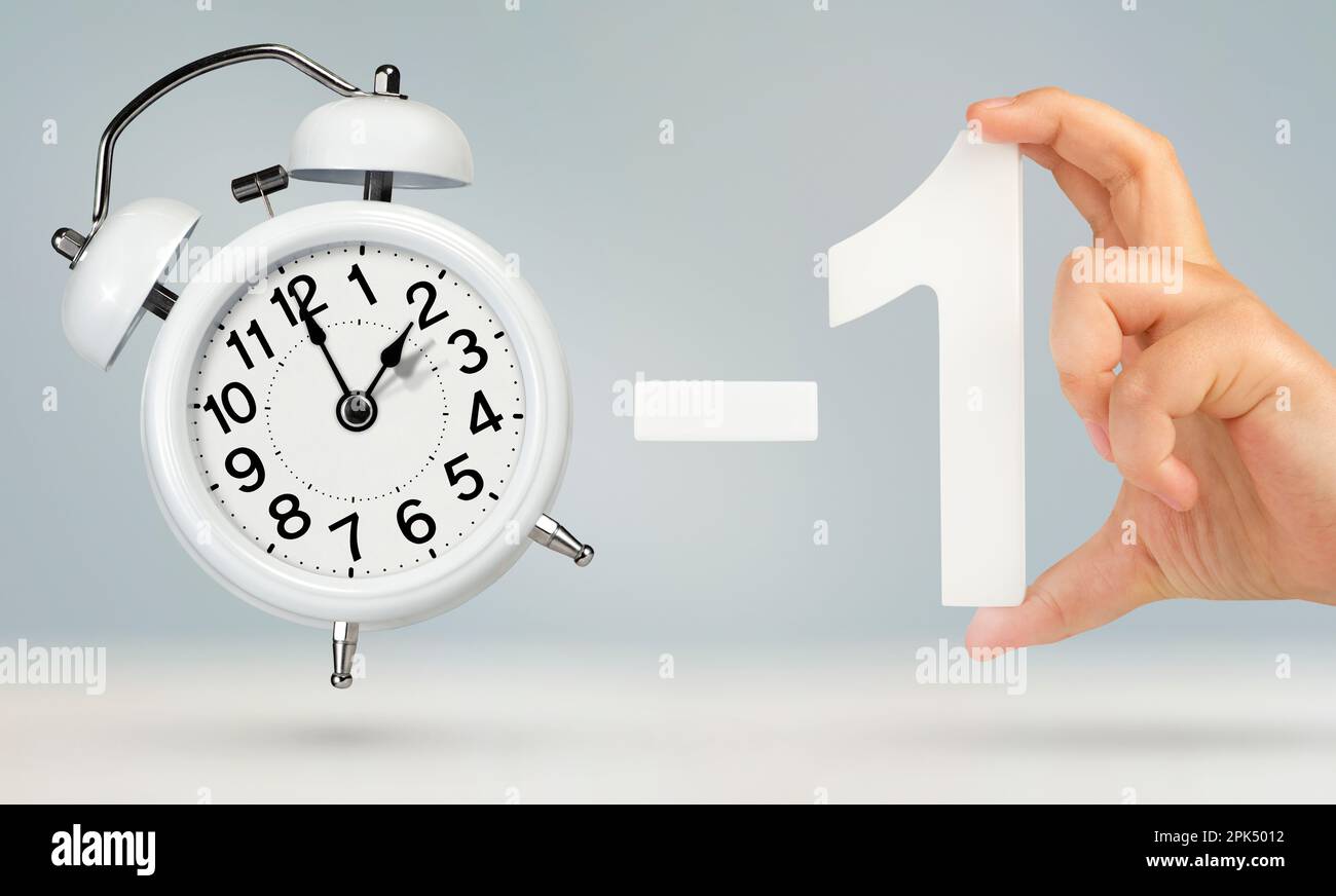 Change time, minus one hour. Fall back, on a gray background. A white ...