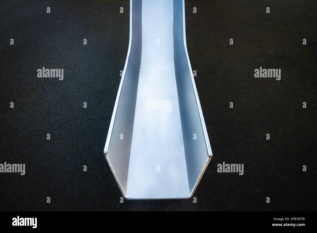 Closeup, bottom of steep stainless steel silver chrome slide. Children ...