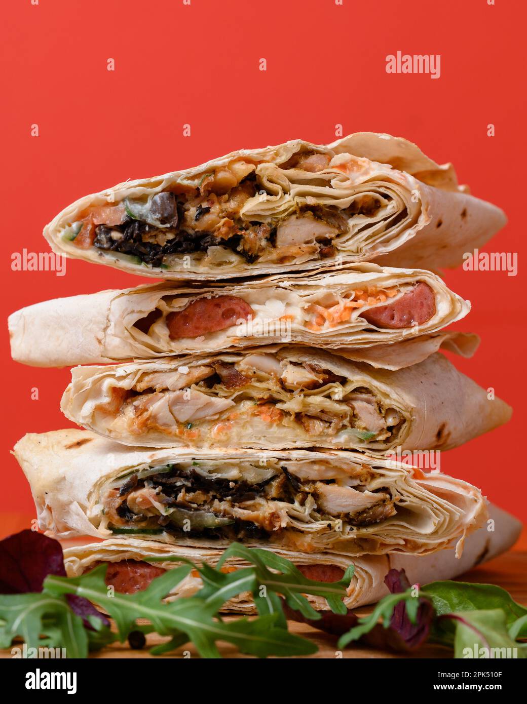 Three types of sliced shawarma stacked on top of each other, red ...