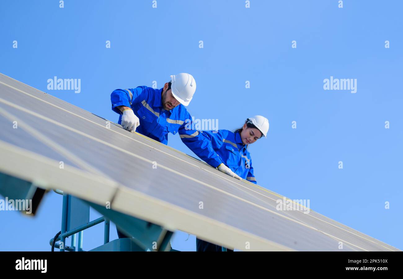 Technicians workers team installing solar panels at industrial solar ...