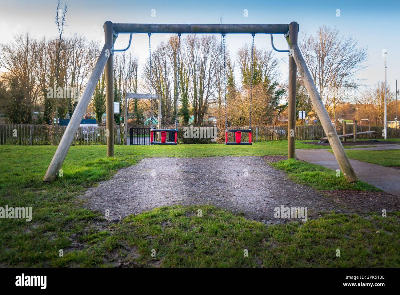 Wooden swingset in outdoor children's playground park. Blue sky ...