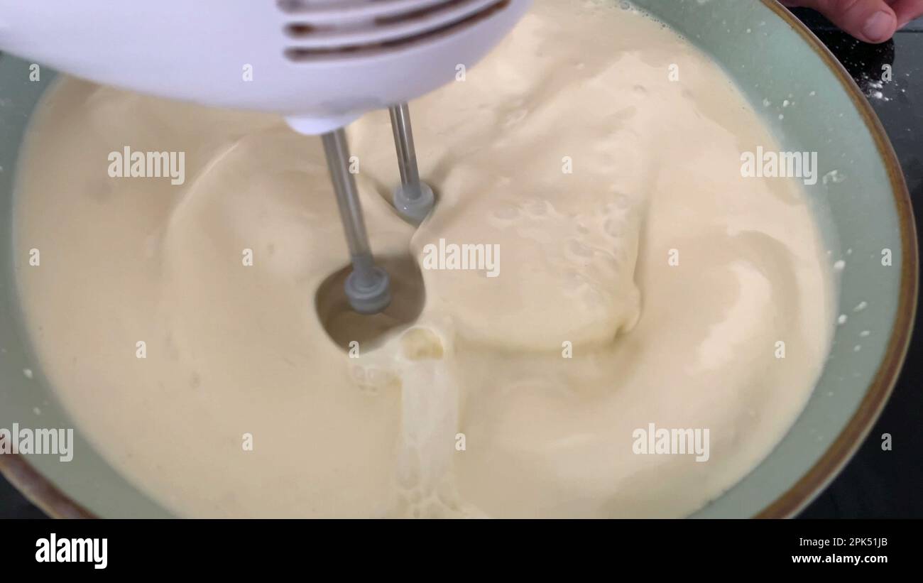 Mixing cream in mixing machine, dough in electric mixer Stock Photo - Alamy