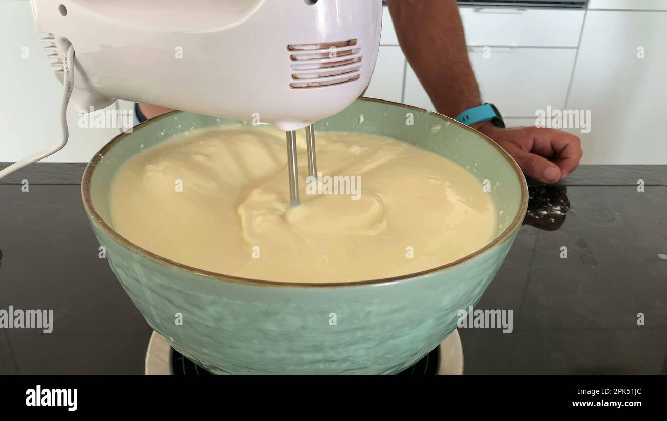 Mixing cream in mixing machine, dough in electric mixer Stock Photo - Alamy