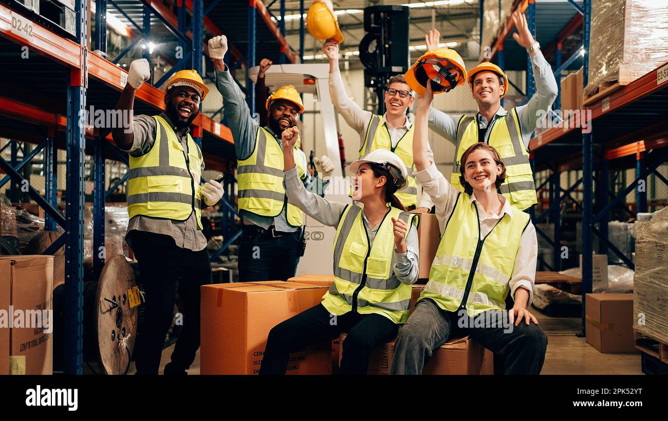 Professional warehouse worker team celebrating success in warehouse ...
