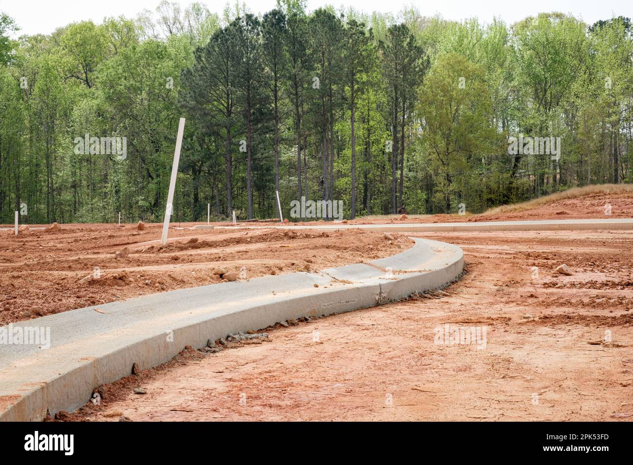 Concrete curbs in new residential subdivision have been poured on red ...