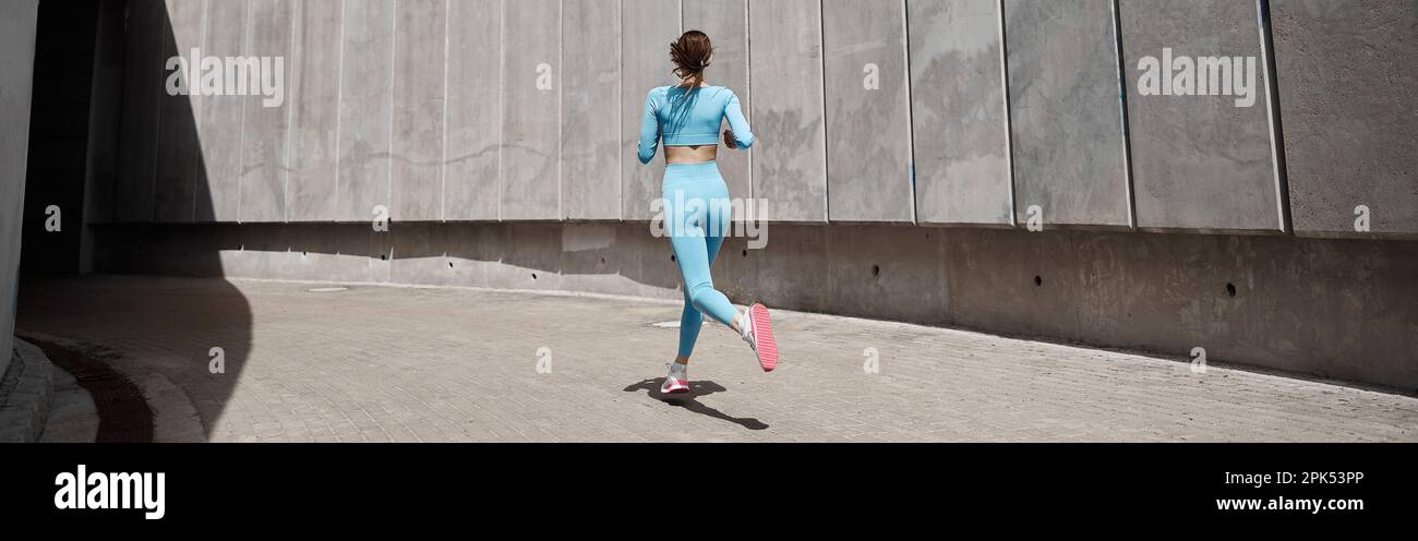 Beautiful fit young woman jogger is running outdoors Stock Photo - Alamy