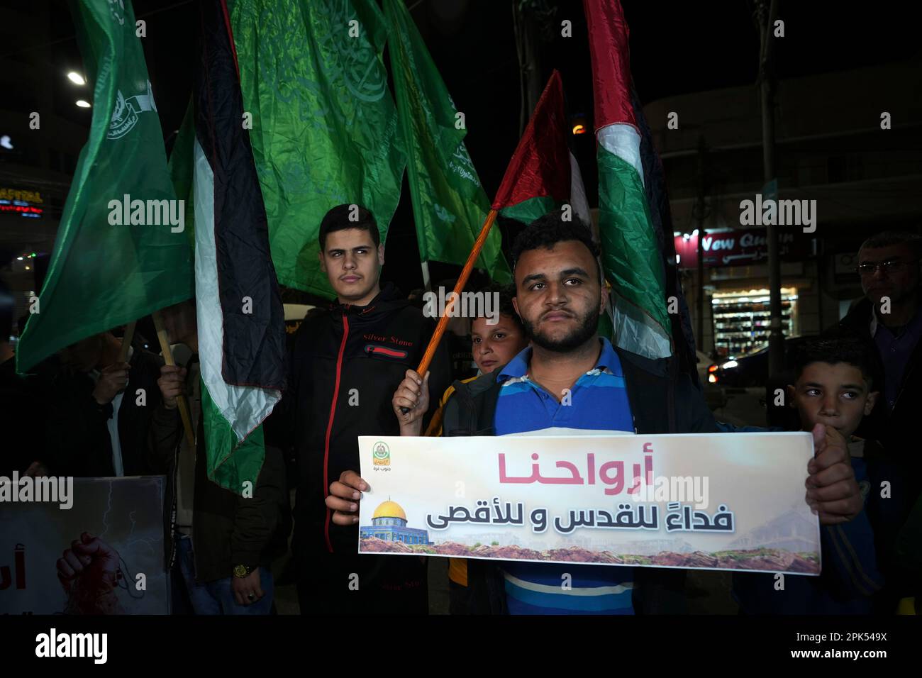 Hamas supporters wave green Islamic and Palestinian national flags ...