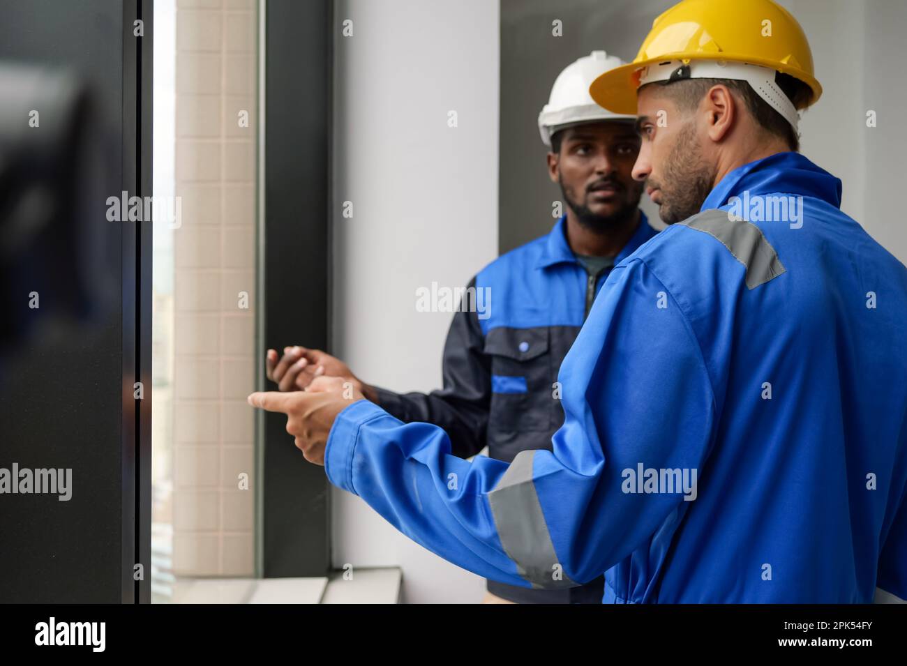 Professional construction engineers team using blueprint of project ...