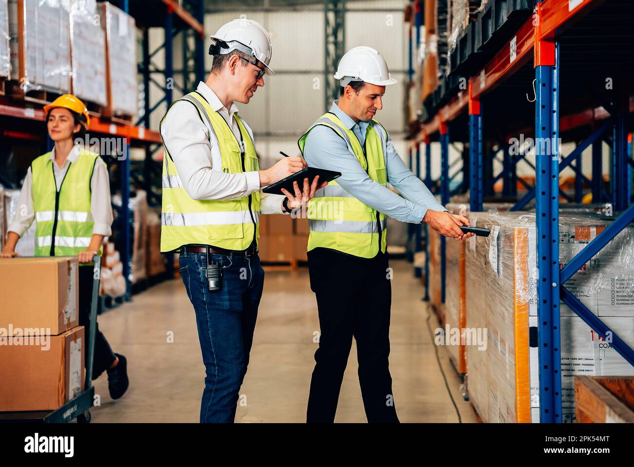Smart male engineer manager wearing safety vest and helmet using ...