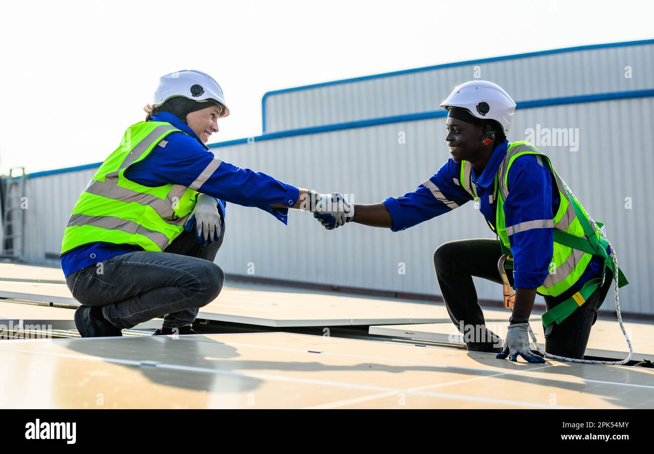 Teamwork technicians workers installing solar panels at solar cell farm ...