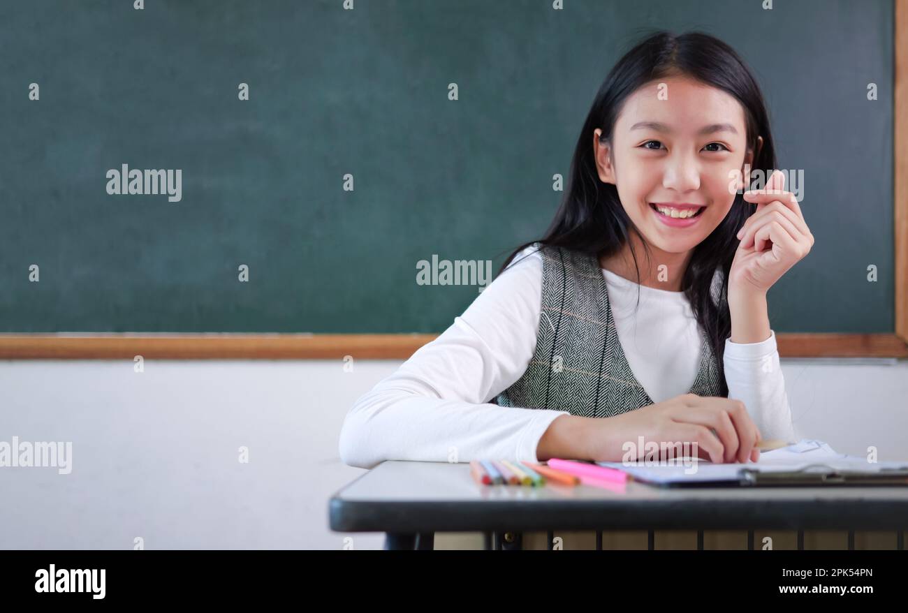 Student studying and reading textbook with happiness in classroom Stock ...