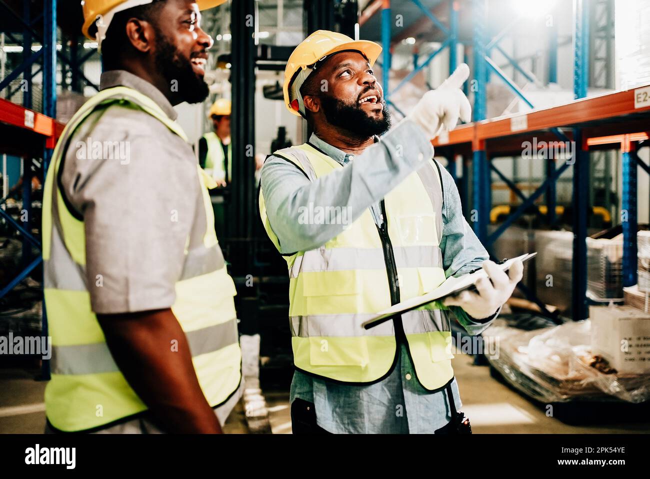 Two warehouse workers checking and controlling boxes in warehouse Stock ...