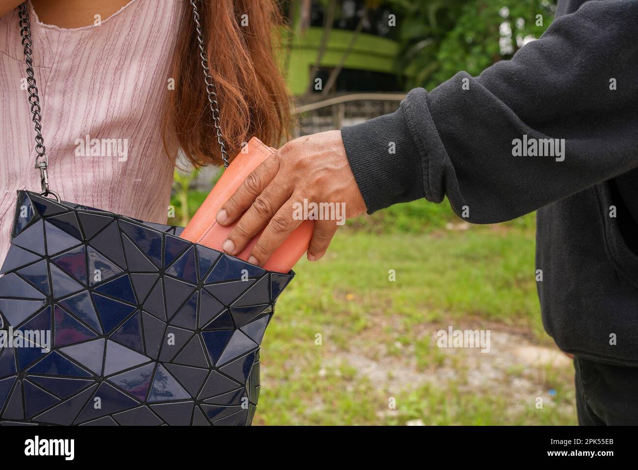 Man robbed woman, Thief stealing in public Stock Photo - Alamy