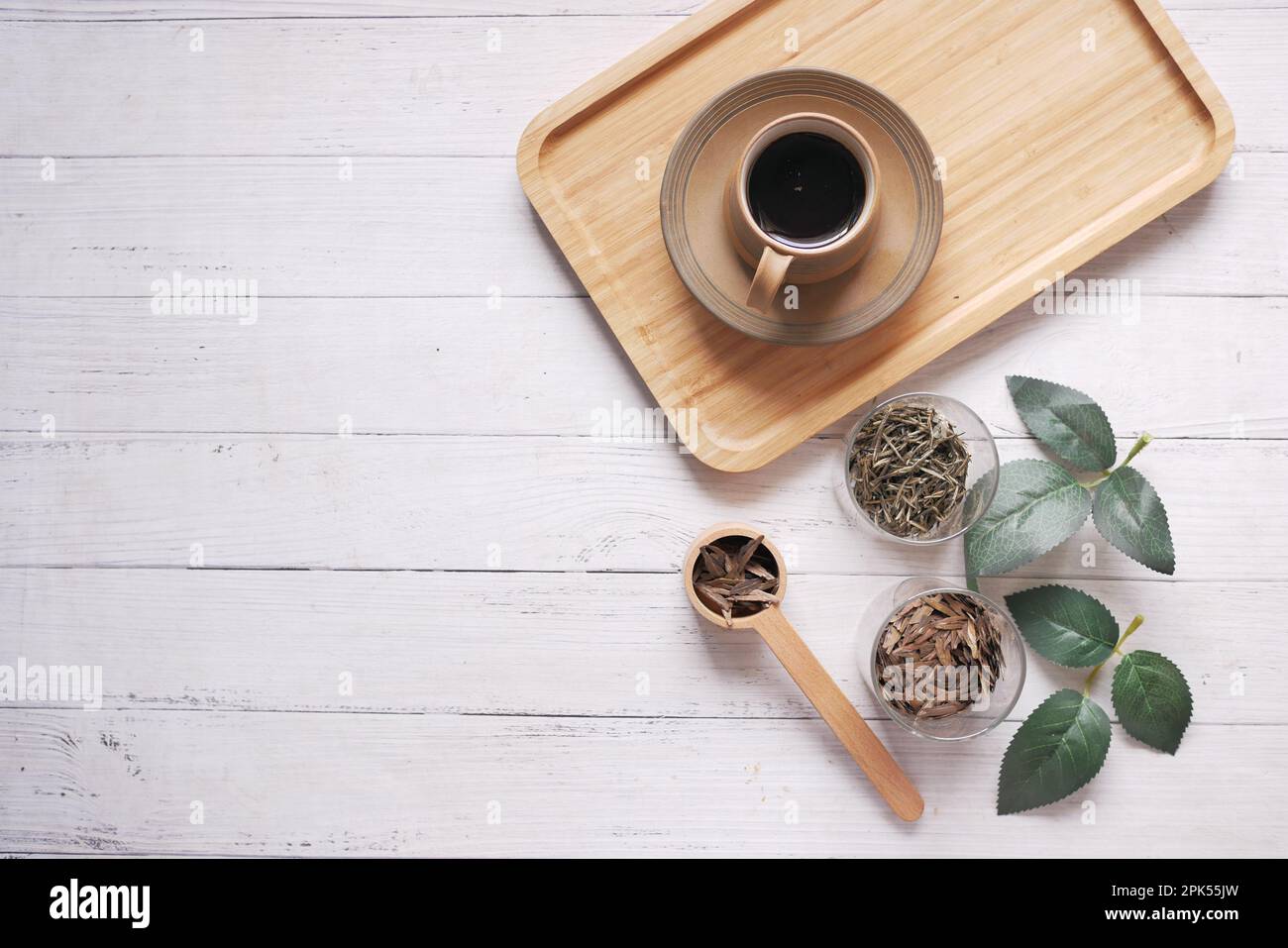 Dry tea leaves on spoon and tea up on table Stock Photo - Alamy