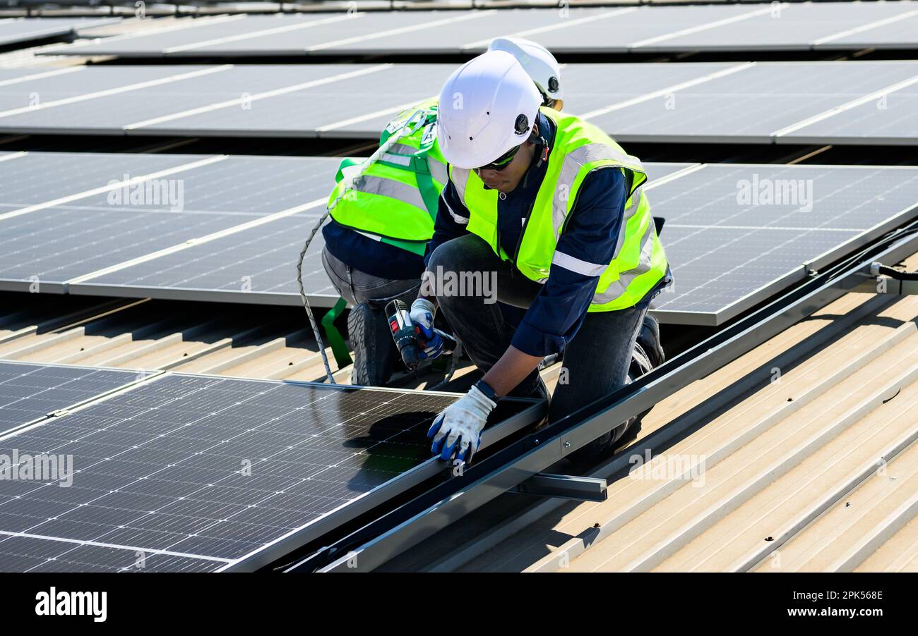 Professional engineer technician with safety helmet checking solar ...