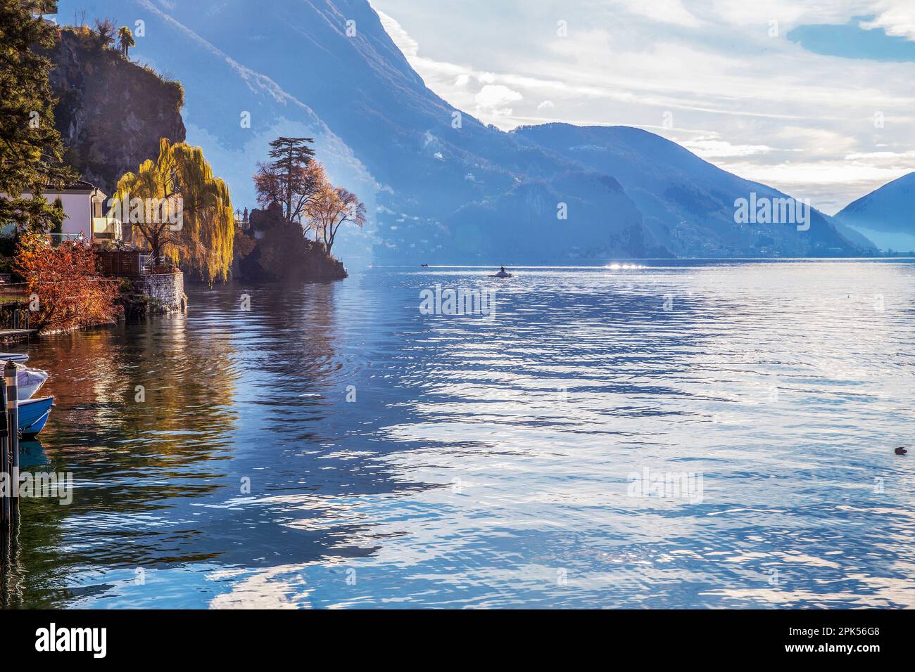 View from shore of lake Lugano. In water competition of canoes and ...