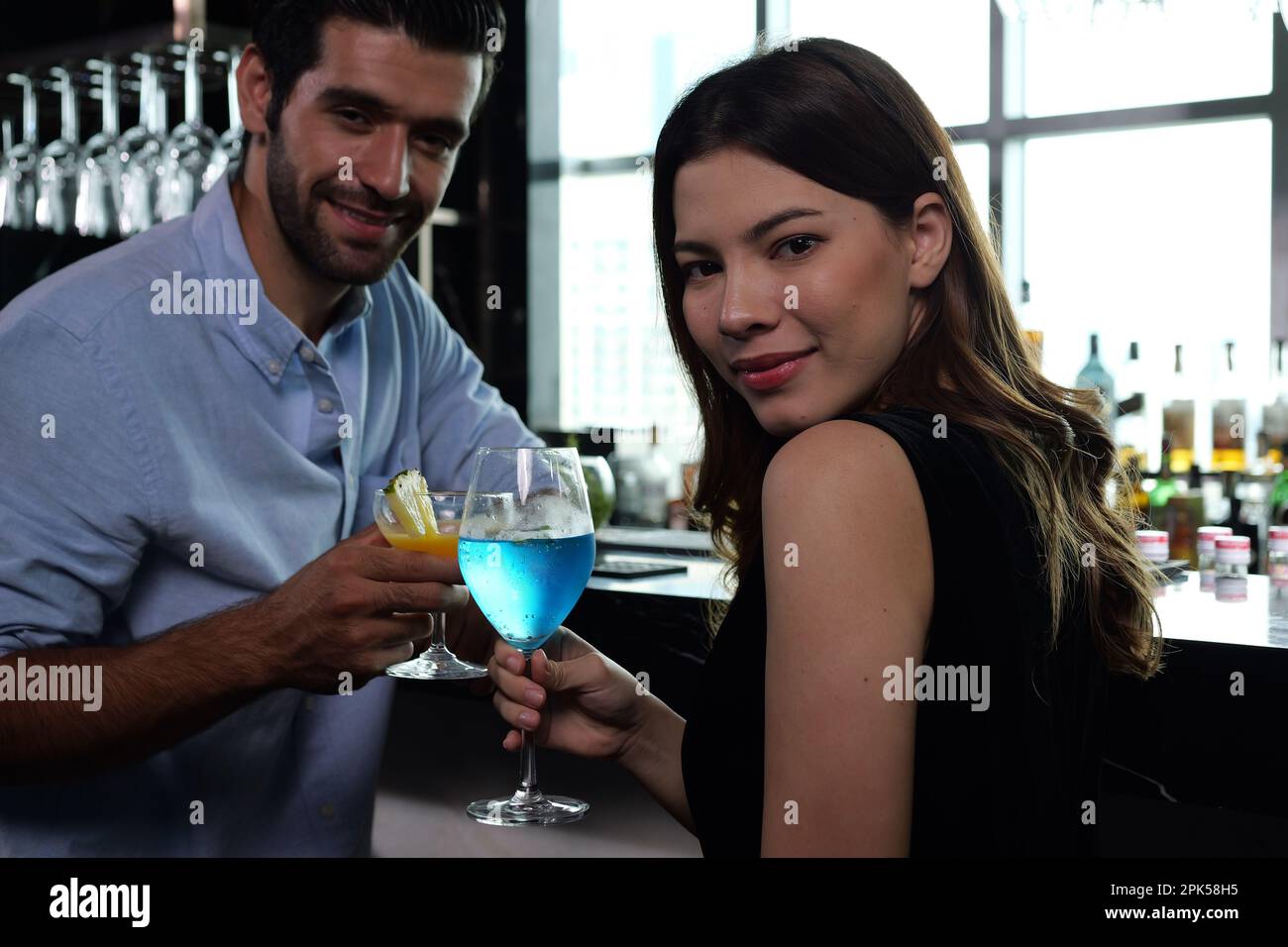 Couple of handsome man and beautiful woman drinking cocktails in luxury ...
