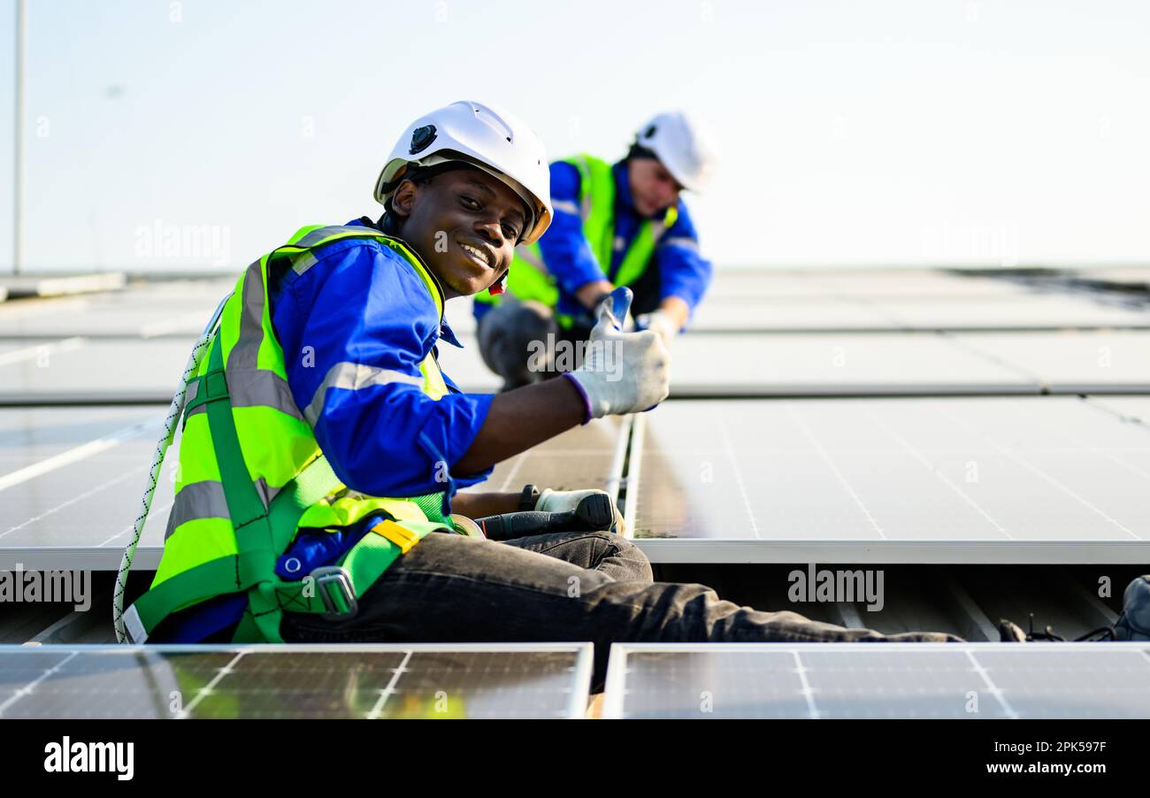 Technicians workers with safety uniform checking photovoltaic panels ...