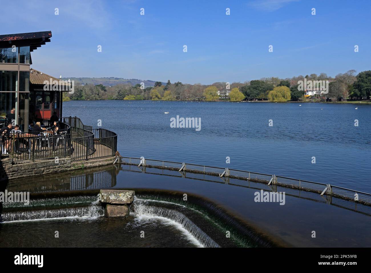 Roath Park lakeside cafe with outdoor seating. Overflow weir / sluice ...