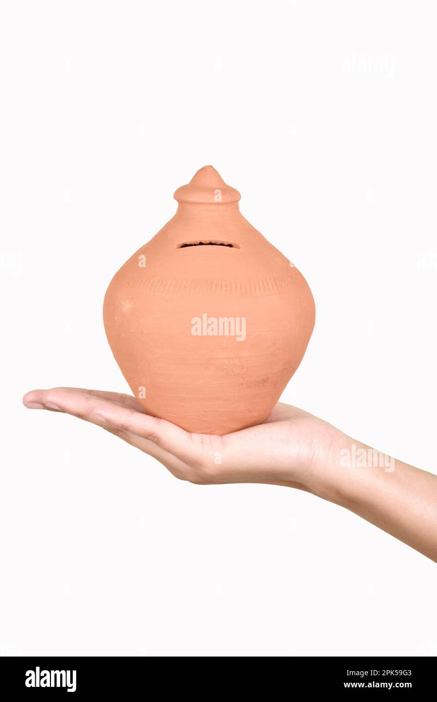 Gullak in hand isolated on white background Stock Photo - Alamy